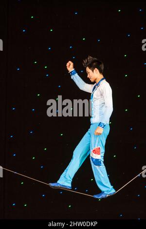 Chinese Male Acrobat Balancing on a Tightrope Stock Photo - Alamy