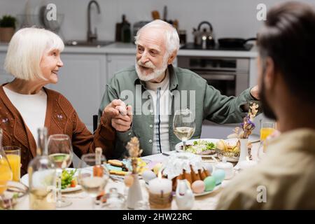 Happy senior couple with easter eggs in basket outdoor Stock Photo - Alamy