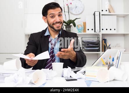 Spanish businessman is talking with partner about contract in office ...