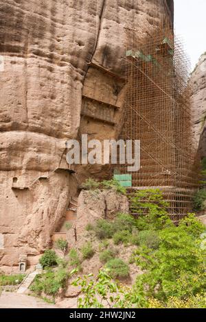 Scaffold / scaffolding on the mountain side where ancient caves were ...