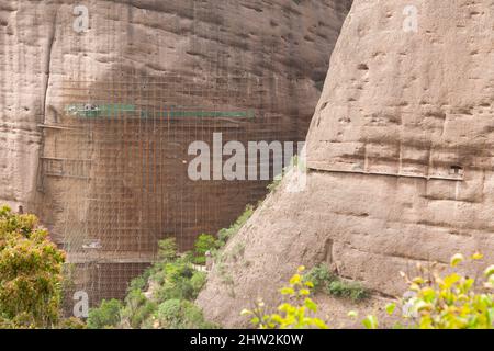 Scaffold / scaffolding on the mountain side where ancient caves were ...