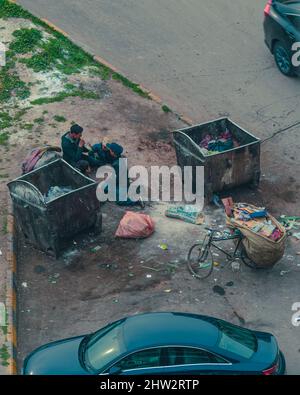 poor kids eating near garbage carts Stock Photo - Alamy