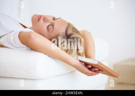 Beautiful woman falling asleep while reading a book Stock Photo - Alamy