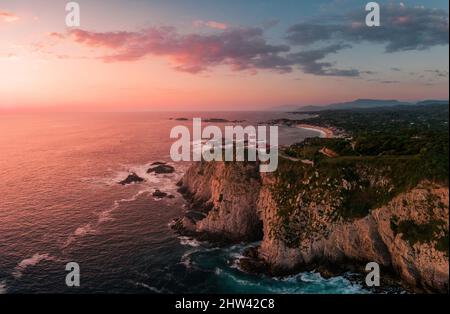 Sunset over a lighthouse at the Maruata beach, Michoacan, Mexico Stock ...