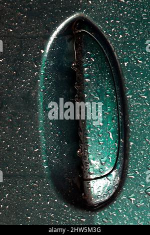 Raindrops on green bonnet of a car Stock Photo - Alamy