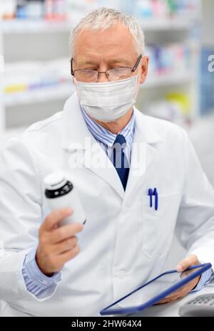old apothecary in mask with tablet pc at pharmacy Stock Photo - Alamy