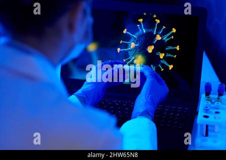 hand holding beaker with coronavirus blood test Stock Photo - Alamy