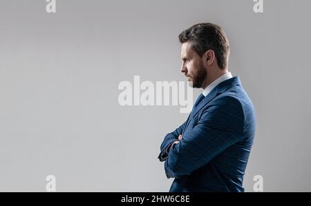 Hes a serious man. Serious businessman sideway grey background ...