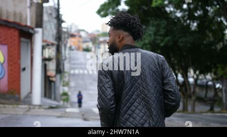 A contemplative African man walking in street Stock Photo - Alamy