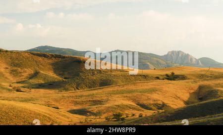 Top view of dry autumn meadows on the hills. Shot. Bright orange grass on a Sunny day Stock ...