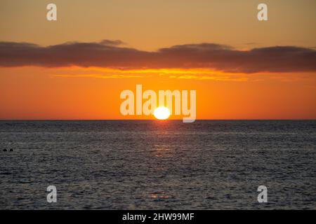 Sun sets behind ocean off Floreana island, Galapagos islands Stock ...