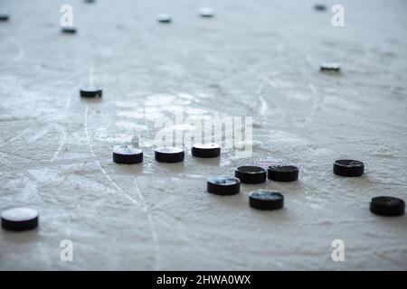 pucks on empty ice rink Stock Photo - Alamy