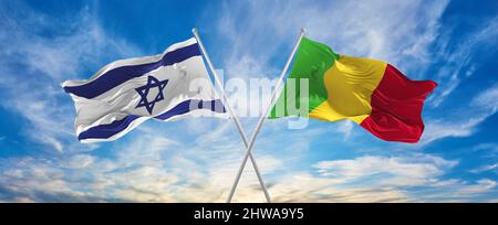 Israel and Mali flag waving in the wind against white cloudy blue sky ...
