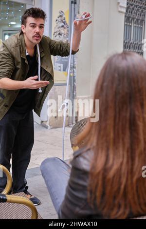 Funny entertainment. Street performance. Magician circus worker. Hocus ...