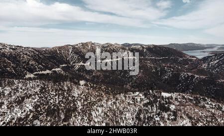 An aerial shot of snowy dry scenery on the road 520 between Sauda and ...