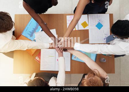 Teamwork and success go hand in hand. High angle shot of a group of ...