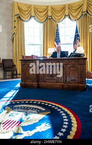 President Joe Biden works at the Resolute Desk, Wednesday, March 22 ...