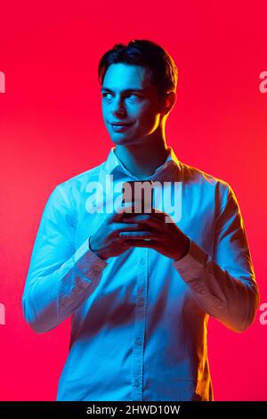 Education concept. A student does homework, looks through a microscope ...