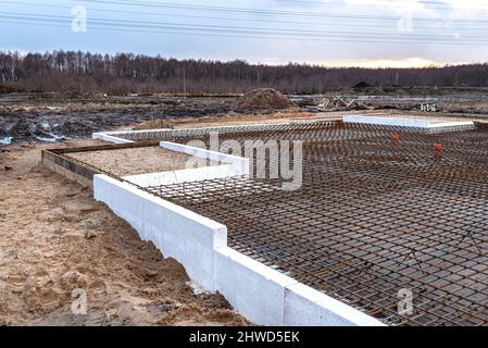 The foundation slab is made of reinforcement rods, bound with tie wire ...