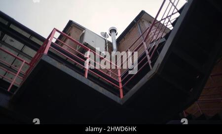 Second floor fire escape exterior of a run down abandoned building that ...