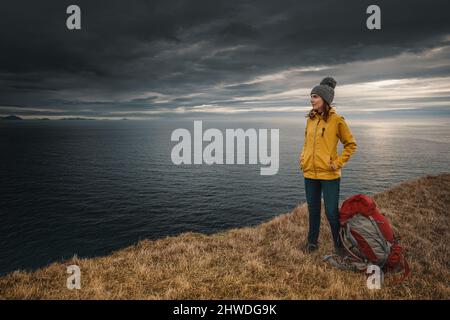 Female backpacker traveller in Iceland watching the Ocean Stock Photo ...
