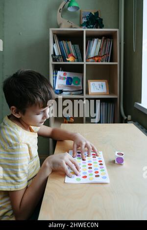 Child playing diy dot game for fingers Stock Photo - Alamy