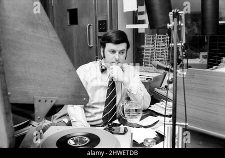 Disc Jockey Terry Wogan enjoys a large jug of water during broadcast of ...