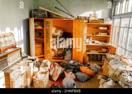 Cluttered storeroom barn with old furniture and assorted debris ...