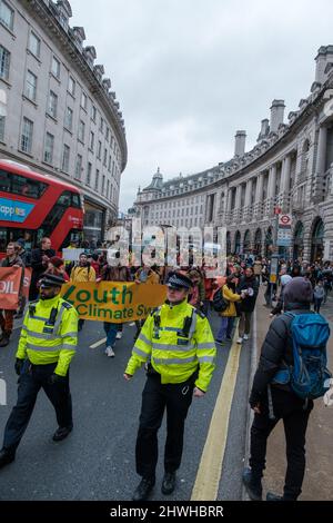 Youth Climate Swarm protest against the use of oil through London ...