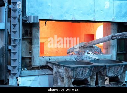 skimming melted aluminum for removing the dross before casting ...