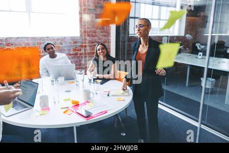 Diverse team strategizing and collaborating in a modern office for a ...
