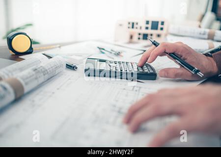 Architect engineer use calculator for calculate drawing design working ...