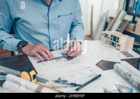 Architect engineer use pen and angle protector drawing design working ...