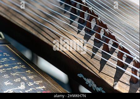ancient Asian stringed musical instrument on black background with ...