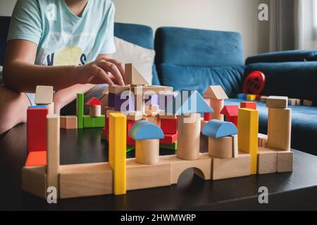 Hand playing with wooden building blocks on white background Stock ...