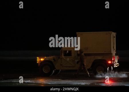 U.S. Army soldiers unload a Humvee in preparation for Exercise Arctic ...