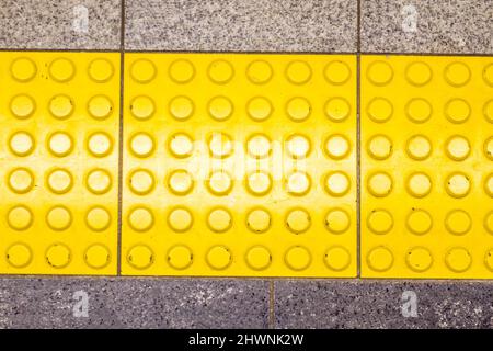 Yellow guiding block brick floor pattern Stock Photo - Alamy