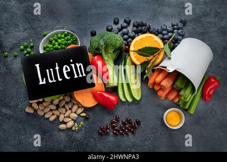 Foods high in lutein on dark background. Food for healthy eyes. High in ...