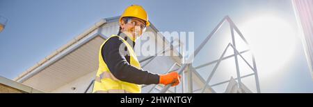 Cheerful male engineer climbing stairs at factory Stock Photo - Alamy
