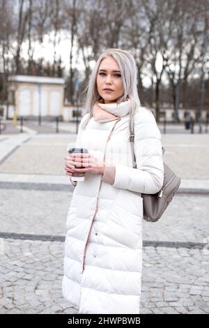 Woman in the street drinking morning coffee and use smartphone Stock ...