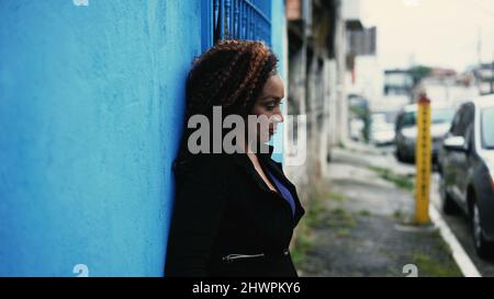 A desperate African woman outside in street feeling anxious Stock Photo ...