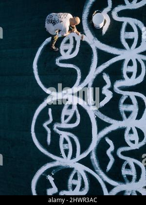 Artist painting graffiti on rooftop Stock Photo - Alamy