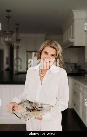 Happy freelancer standing with laptop in garden Stock Photo - Alamy