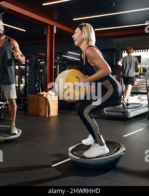 The guy tries to keep his balance on the balancing platform. Massive ...