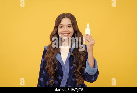 cheerful kid girl free stuffy nose with nasal drops in knitwear on blue ...