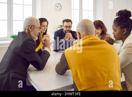 A Group Of Men Praying Together Stock Photo - Alamy