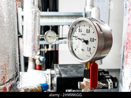 Barometers on pressure pipes, underground premises of the factory Stock ...