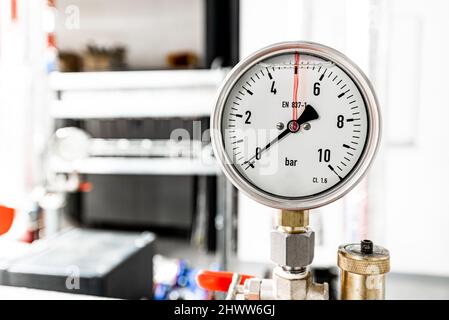 Barometers on pressure pipes, underground premises of the factory Stock ...
