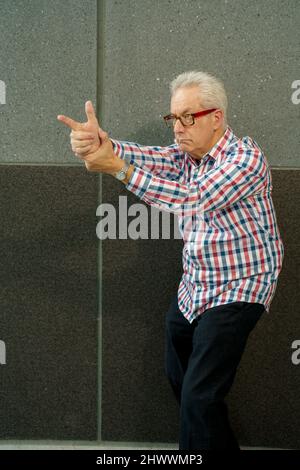 Man pointing a fake finger gun at camera Stock Photo - Alamy