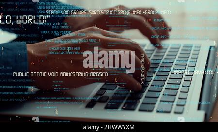 Computer programmer uses capable laptop computer to develop programming code of new software ...